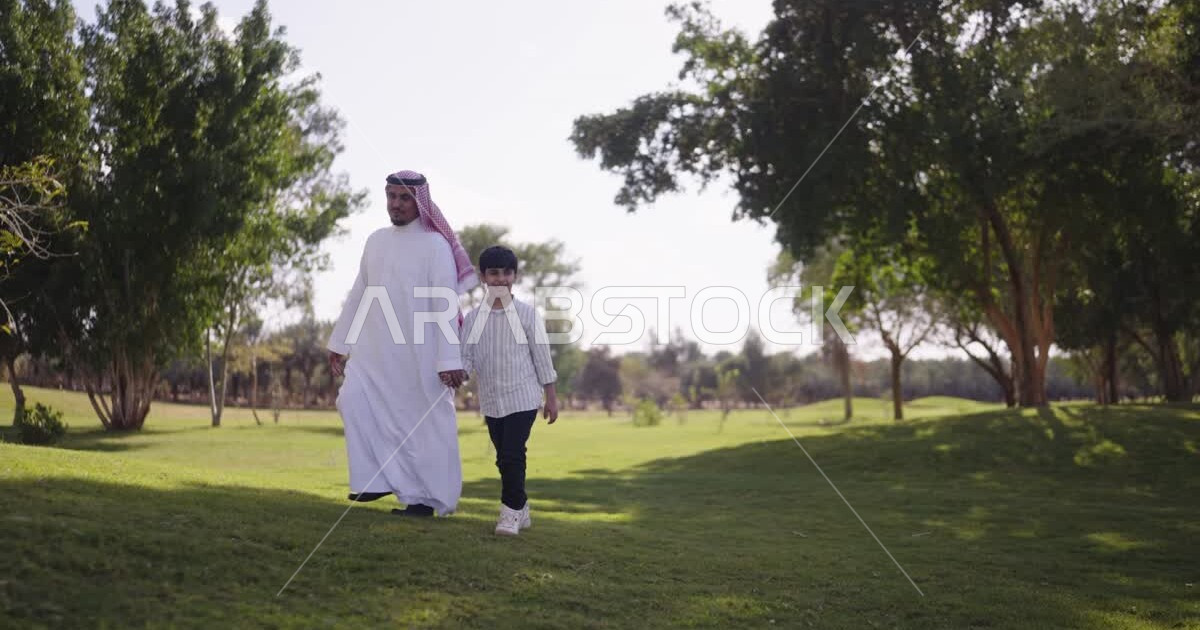 A Saudi Gulf Arab man spends fun times with his son, a tour in a public ...