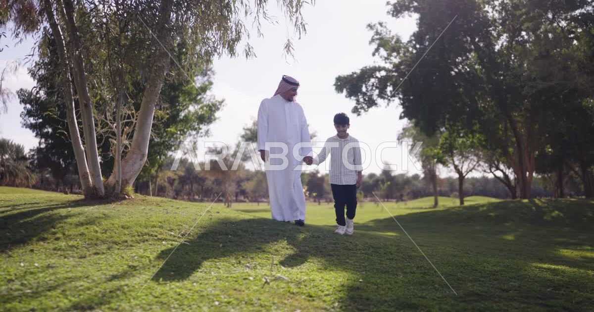 A Saudi Gulf Arab man spends fun times with his son, a tour in a public ...