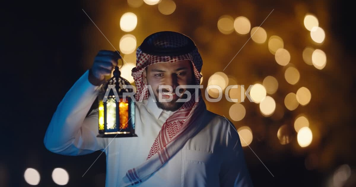 A Saudi Gulf Arab man holding a Ramadan lantern, Ramadan lantern, the ...