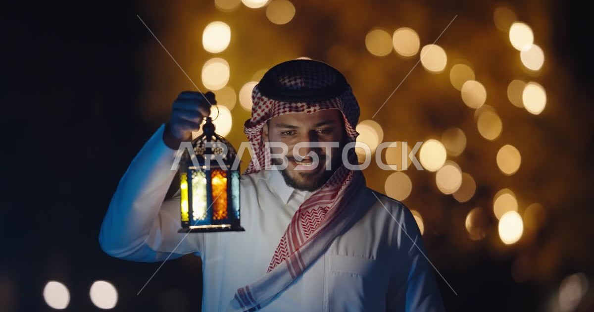 A Saudi Gulf Arab man holding a Ramadan lantern, Ramadan lantern, the ...
