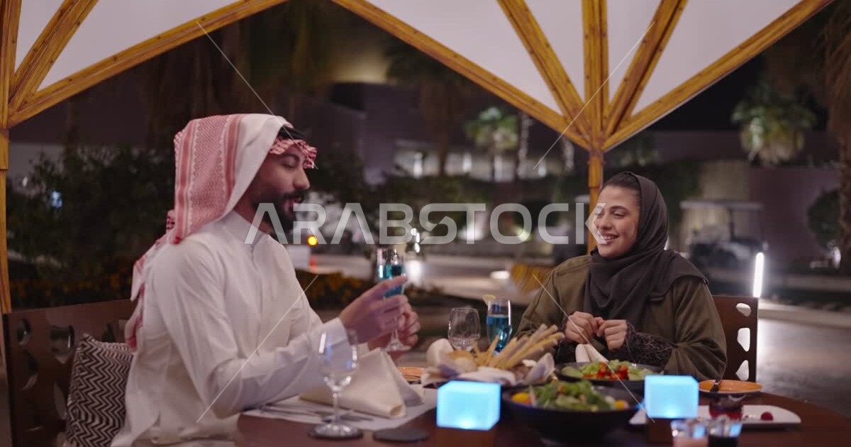 A Saudi Arab Gulf couple enjoying an exchange of conversation in a ...