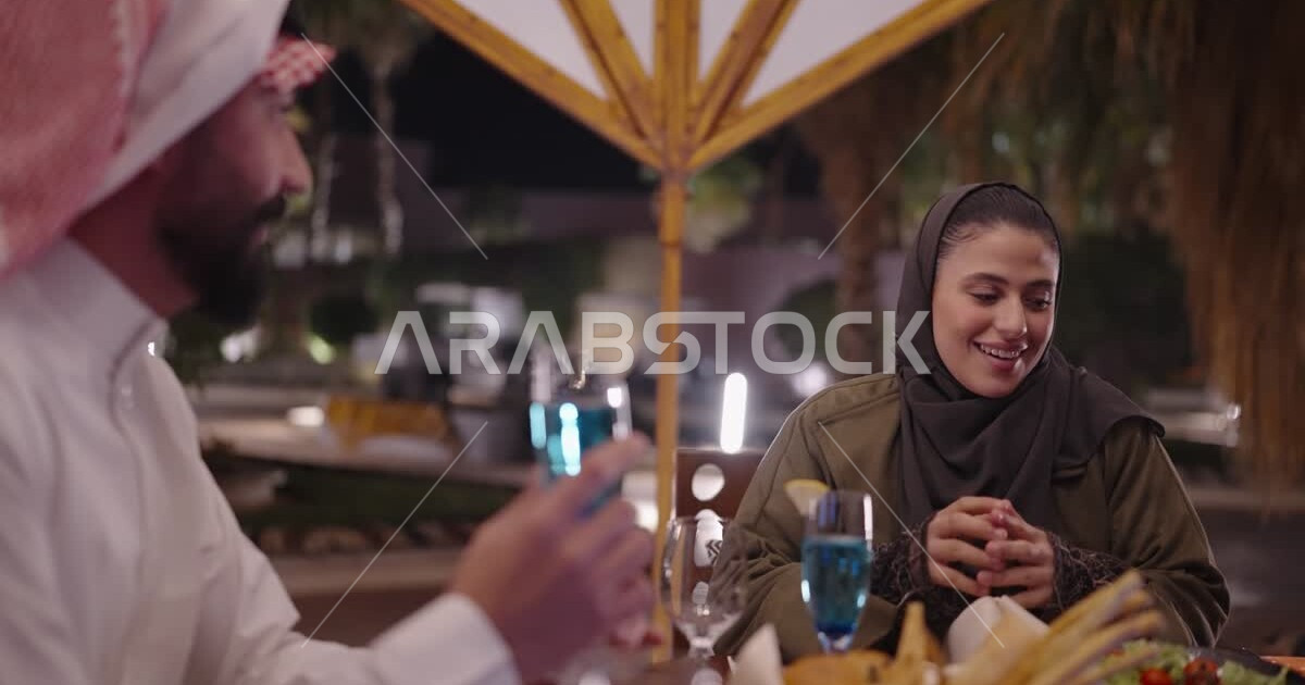 A Saudi Arab Gulf couple enjoying an exchange of conversation in a ...