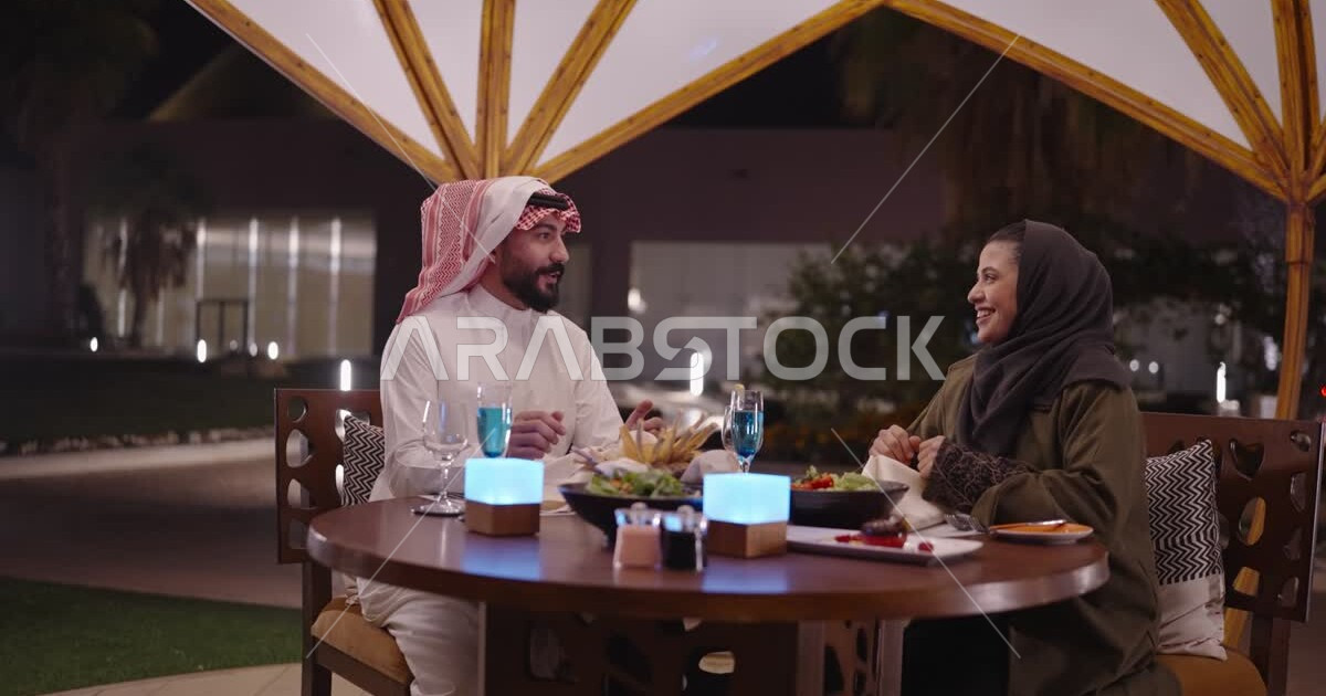 A Saudi Arab Gulf couple enjoying an exchange of conversation in a ...
