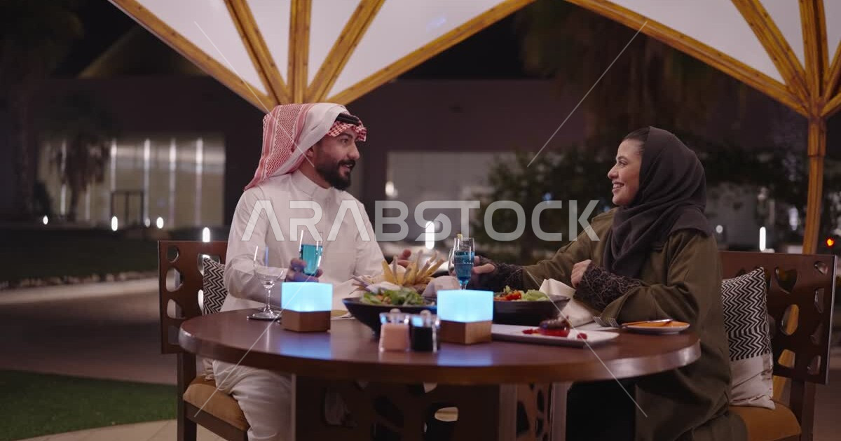A Saudi Arab Gulf couple enjoying an exchange of conversation in a ...