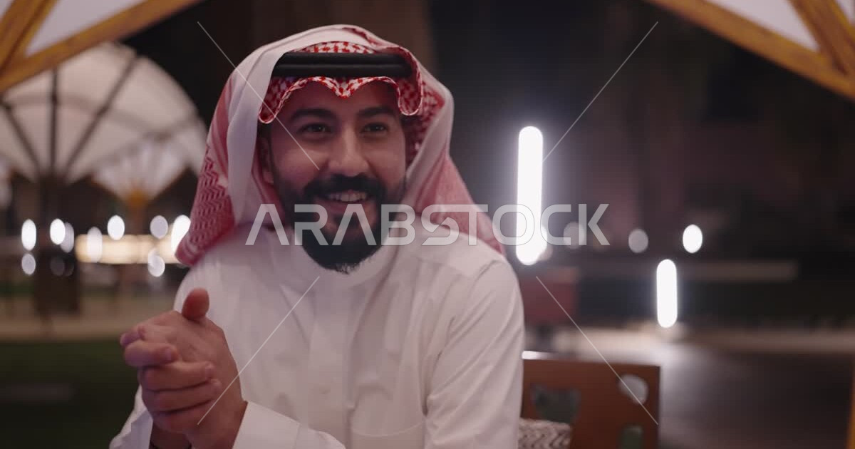 A Saudi Arab Gulf couple enjoying an exchange of conversation in a ...