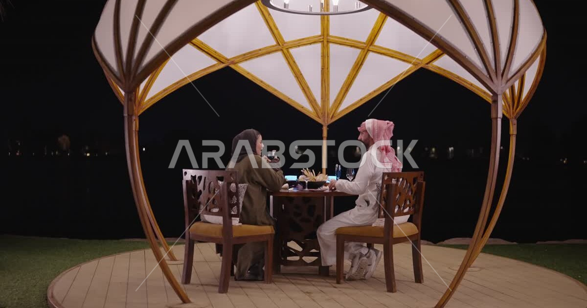 A Saudi Arab Gulf couple enjoying an exchange of conversation in a ...