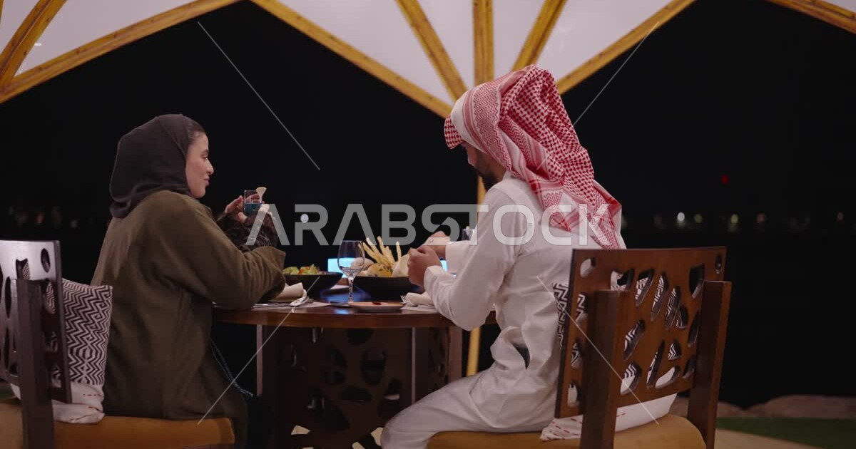 A Saudi Arab Gulf couple enjoying an exchange of conversation in a ...
