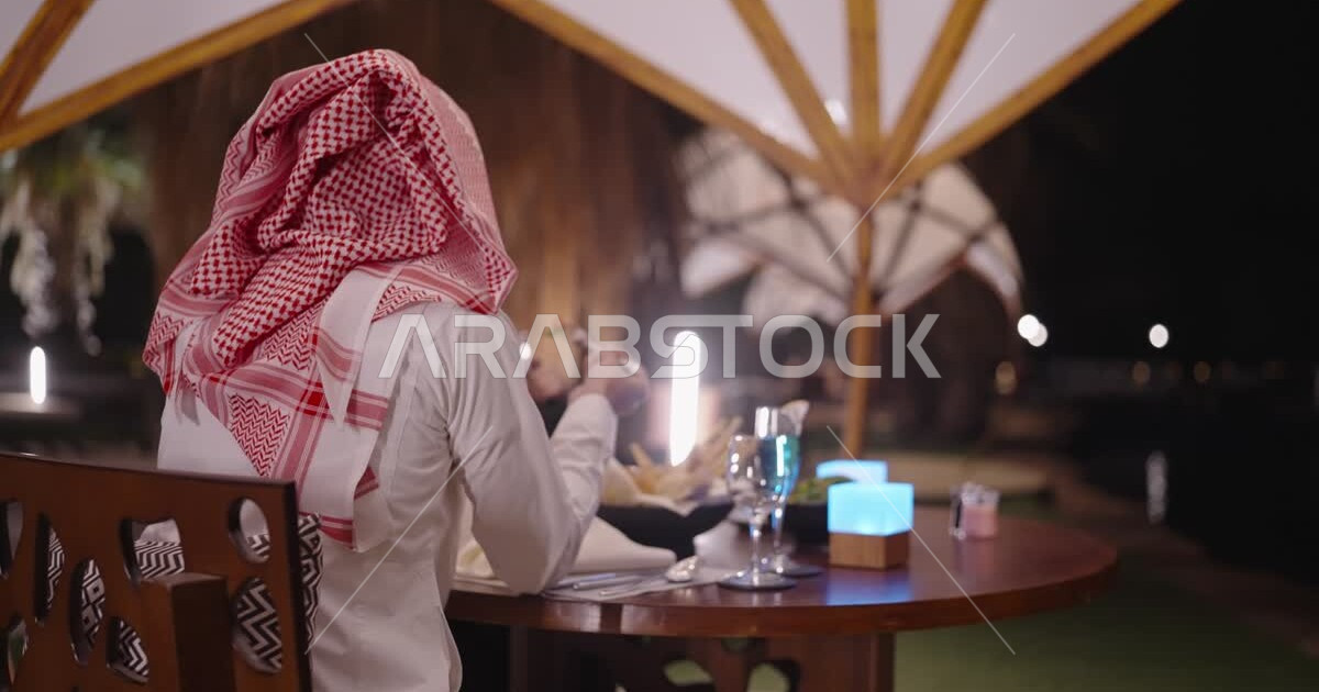 A Saudi Arab Gulf couple enjoying an exchange of conversation in a ...