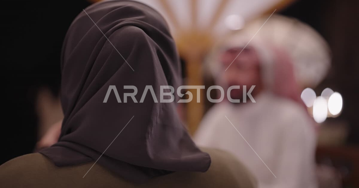 A Saudi Arab Gulf couple enjoying an exchange of conversation in a ...