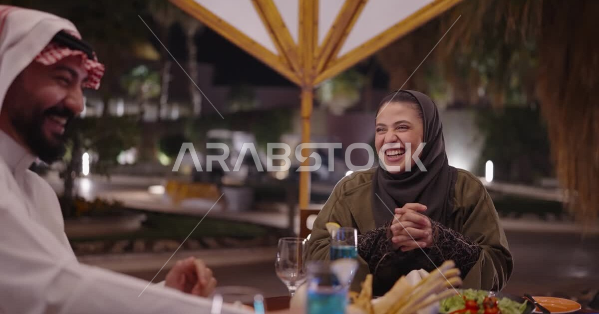 A Saudi Arab Gulf couple enjoying an exchange of conversation in a ...
