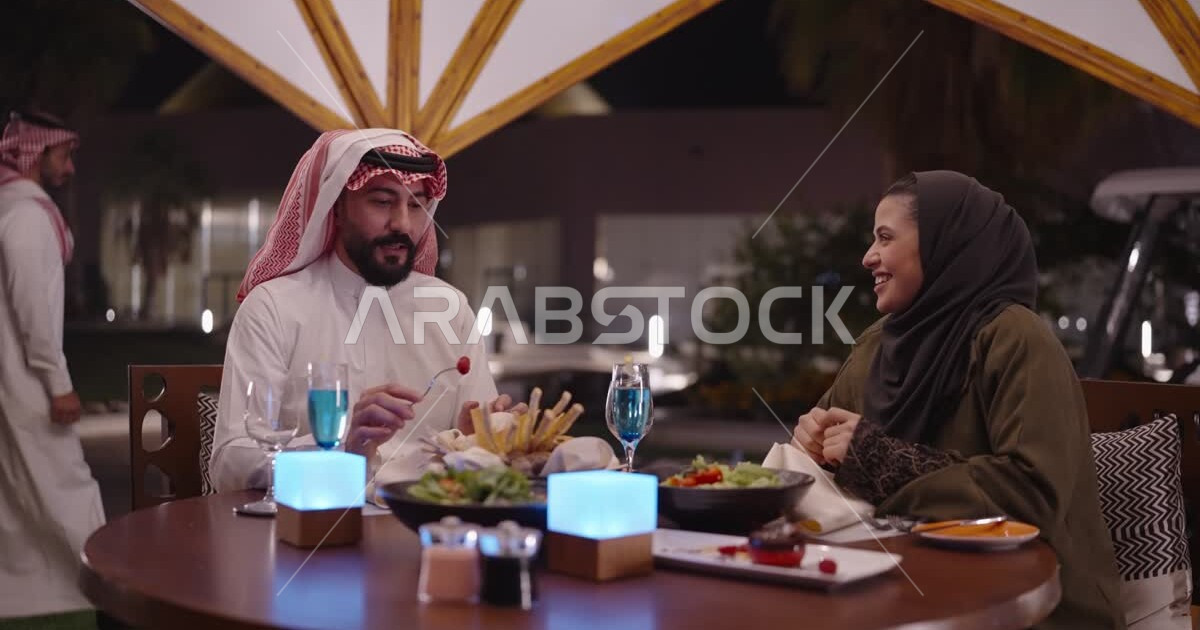 A Saudi Arab Gulf couple enjoying an exchange of conversation in a ...