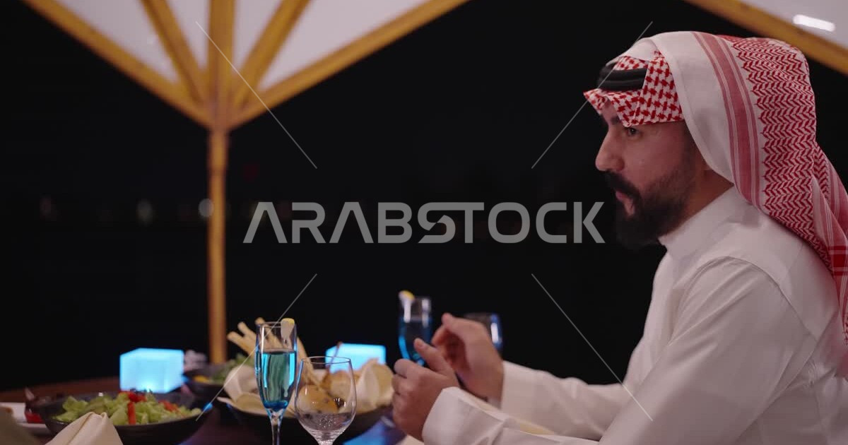 A Saudi Arab Gulf couple enjoying an exchange of conversation in a ...