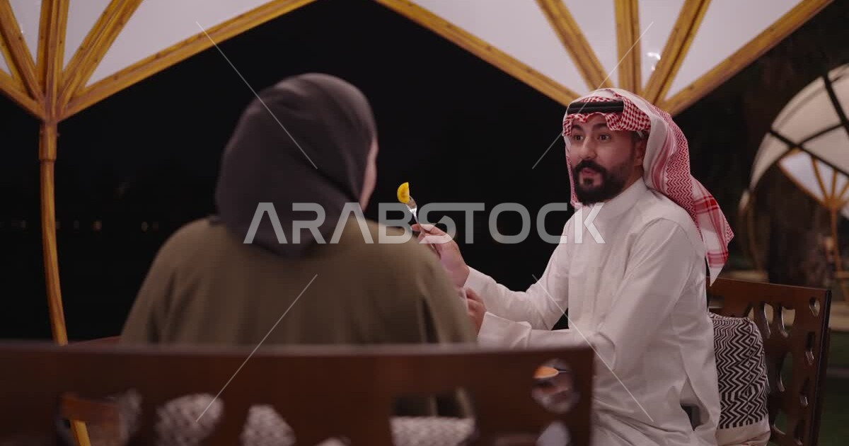 A Saudi Arab Gulf couple enjoying an exchange of conversation in a ...