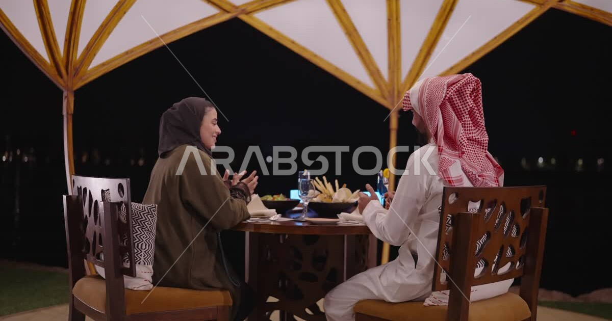 A Saudi Arab Gulf couple enjoying an exchange of conversation in a ...