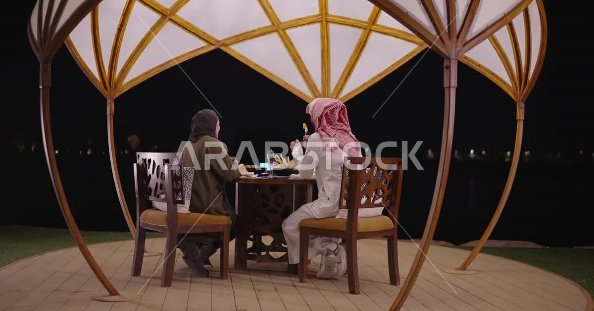 A Saudi Arab Gulf couple enjoying an exchange of conversation in a ...