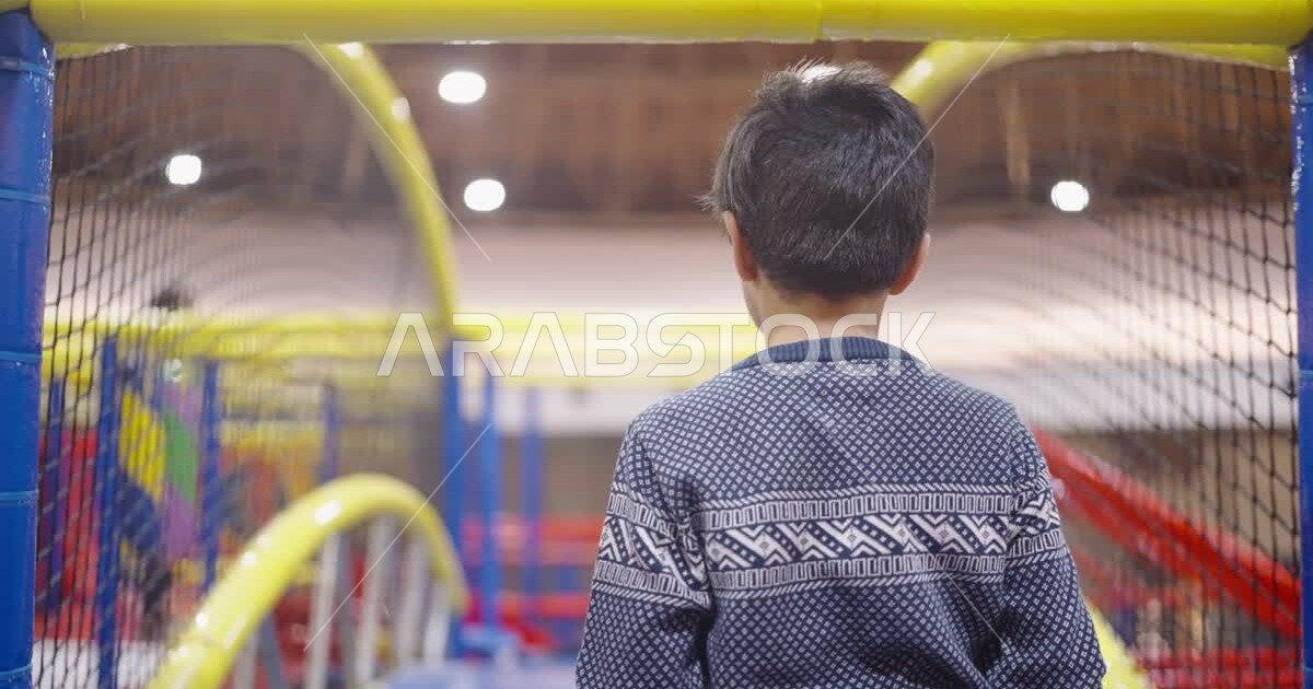 A Saudi Arabian Gulf child enjoys playing, entertaining and ...