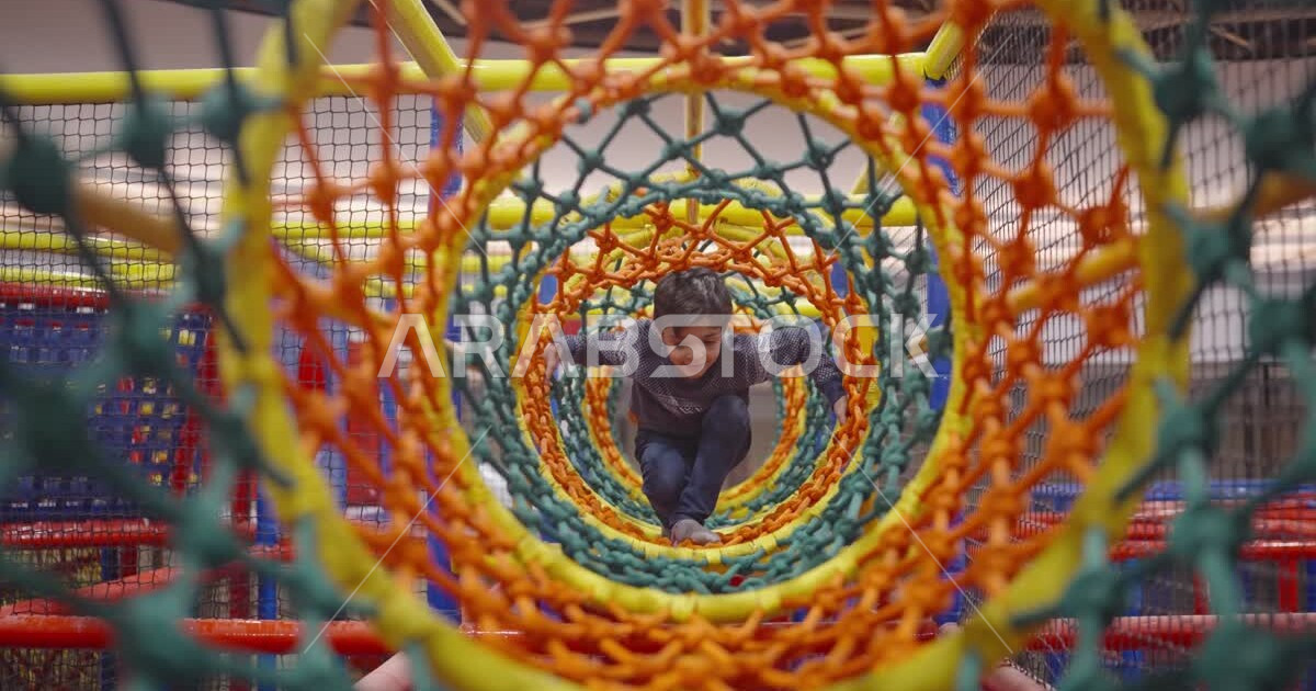 A Saudi Arabian Gulf child enjoys playing, entertaining and ...