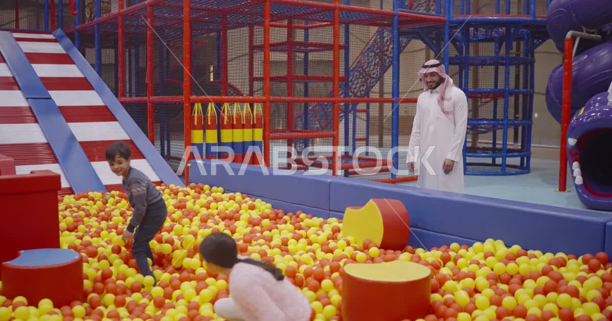 A Saudi Arabian Gulf man spending fun times with his children, two ...