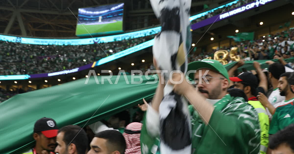 The fans of the Saudi national team cheer and encourage the Saudi ...