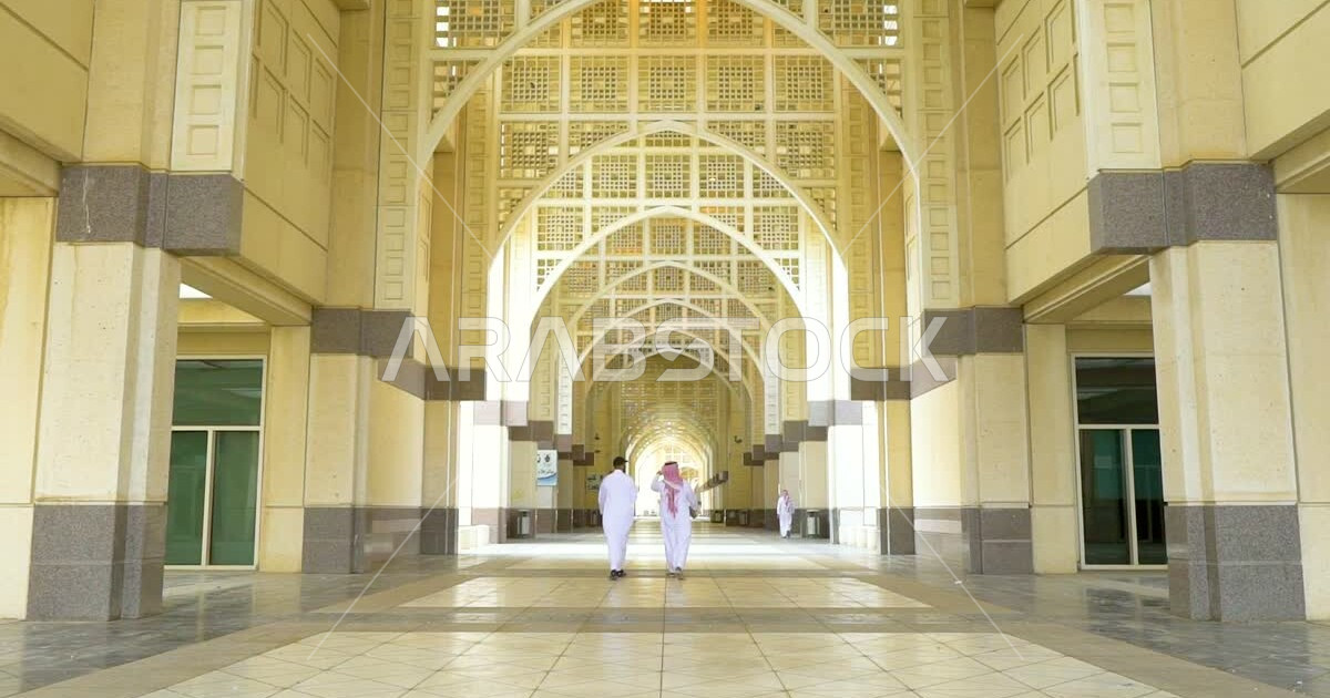 A young Saudi man walks around the campus, an upscale and modern ...