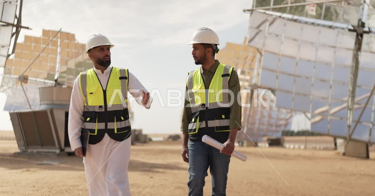 Two Saudi Arabian Gulf engineers, wearing a helmet and a protective ...