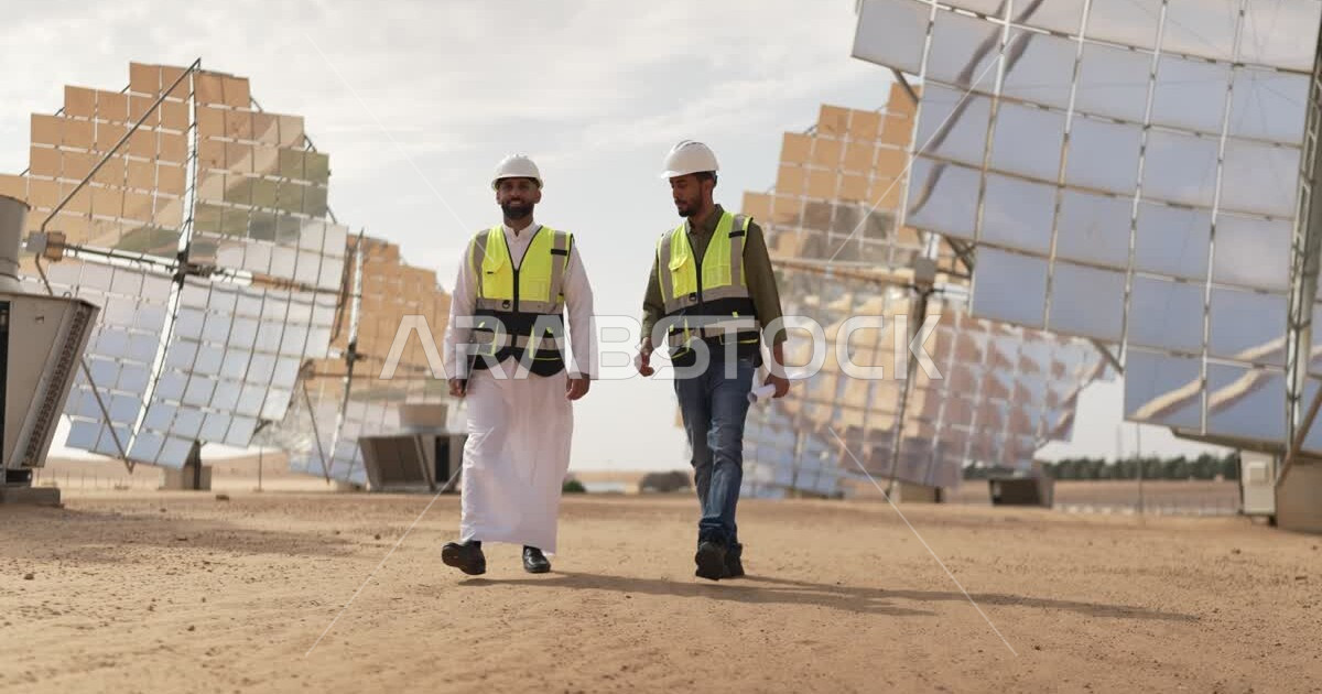 Two Saudi Arabian Gulf engineers, wearing a helmet and a protective ...