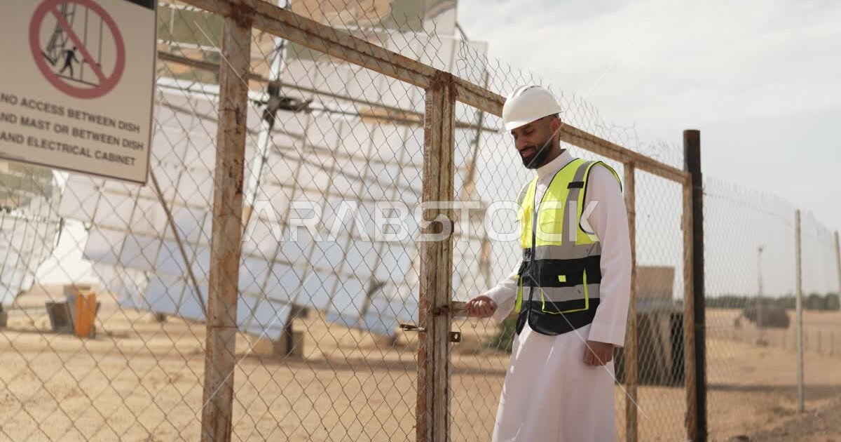 Saudi Arab Gulf engineer, wearing a helmet and work protection jacket ...
