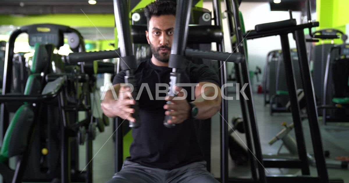 A young Saudi Arabian Gulf man exercising the chest muscle, a Saudi ...
