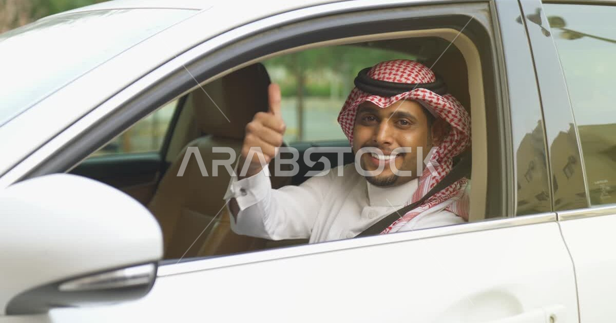 A Saudi Arabian Gulf man inside the car raises his thumbs up, a driver ...