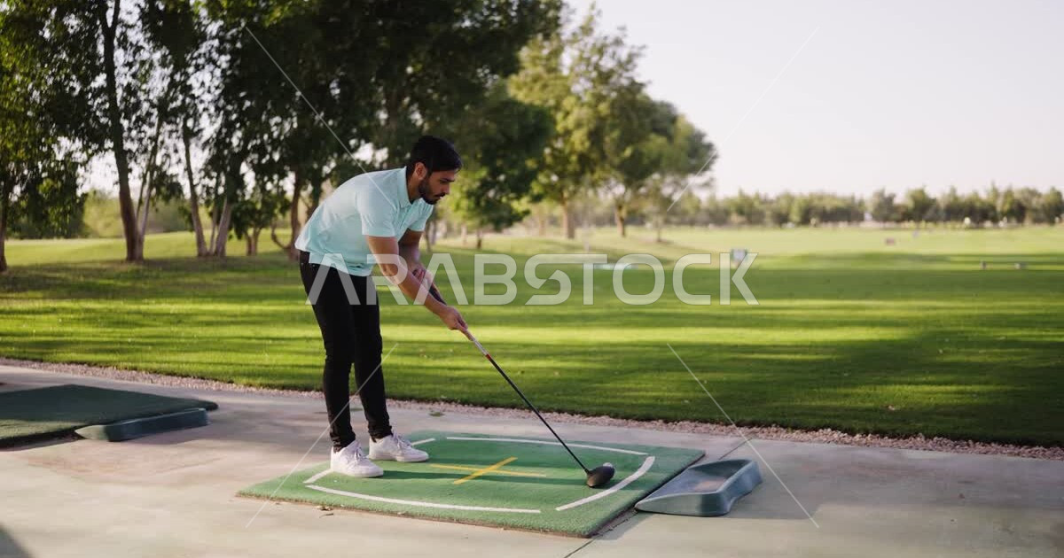 A Saudi Arabian Gulf man on the golf course, playing golf on large ...