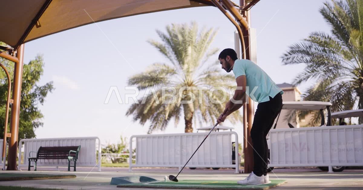 Saudi Arabian Gulf man on the golf course, playing golf, sports ...
