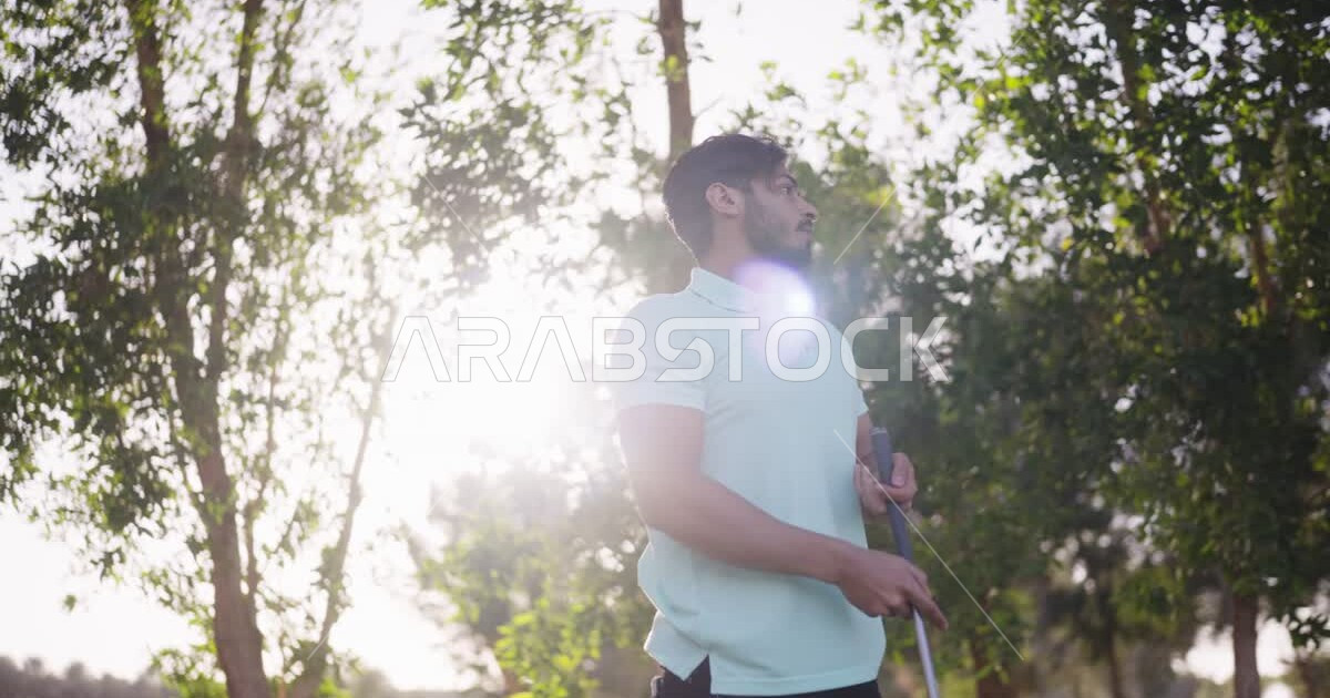 Saudi Arabian Gulf man on the golf course, getting ready to play golf ...