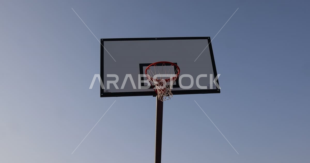 Close-up shooting basketball on the hoop, playing basketball in public ...