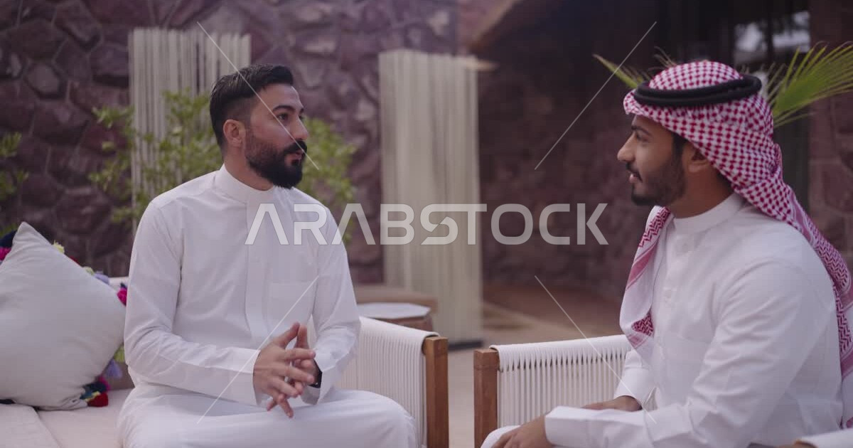 Two Saudi Arabian Gulf men in a tourist chalet in Saudi Arabia, outdoor ...