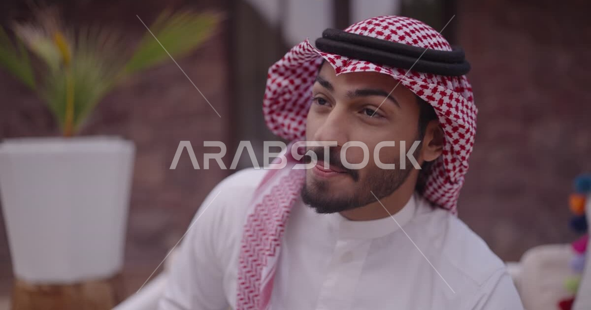 Two Saudi Arabian Gulf men in a tourist chalet in Saudi Arabia, outdoor ...