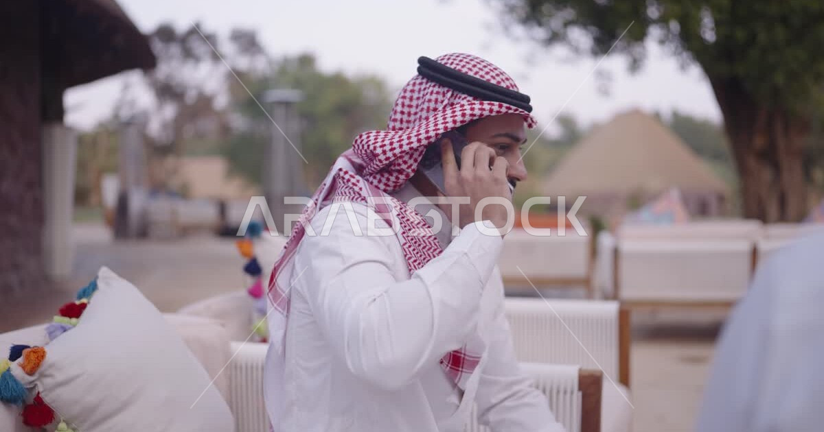 Two Saudi Arabian Gulf men in a tourist chalet in Saudi Arabia, making ...