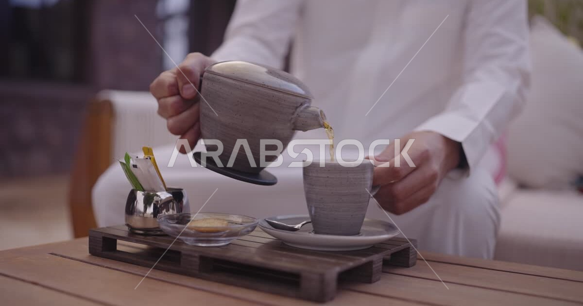 Close-up of a Saudi Arabian Gulf man, drinking hot tea, outdoor ...