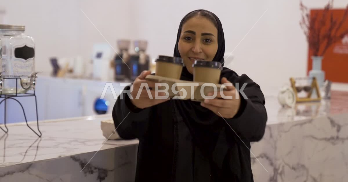Saudi Arabian Gulf woman wearing hijab and abaya in the coffee shop ...