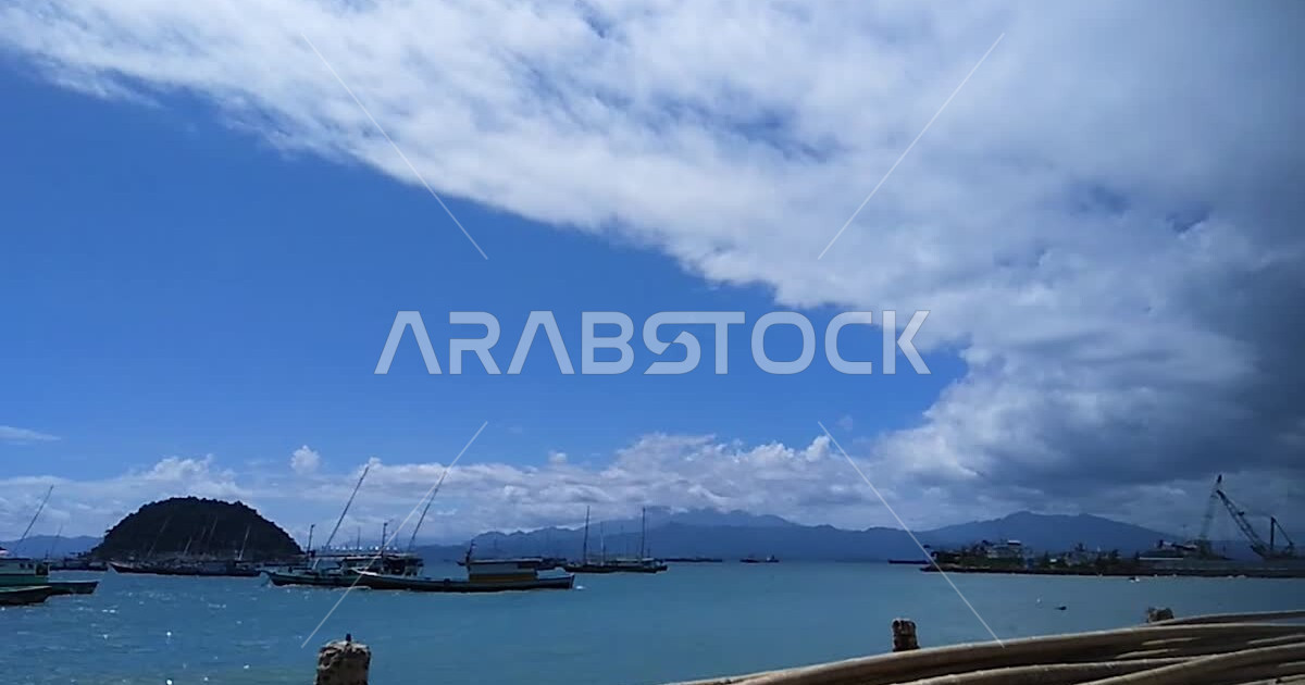 View of the sea during the day, clouds moving, mountains and islands in ...