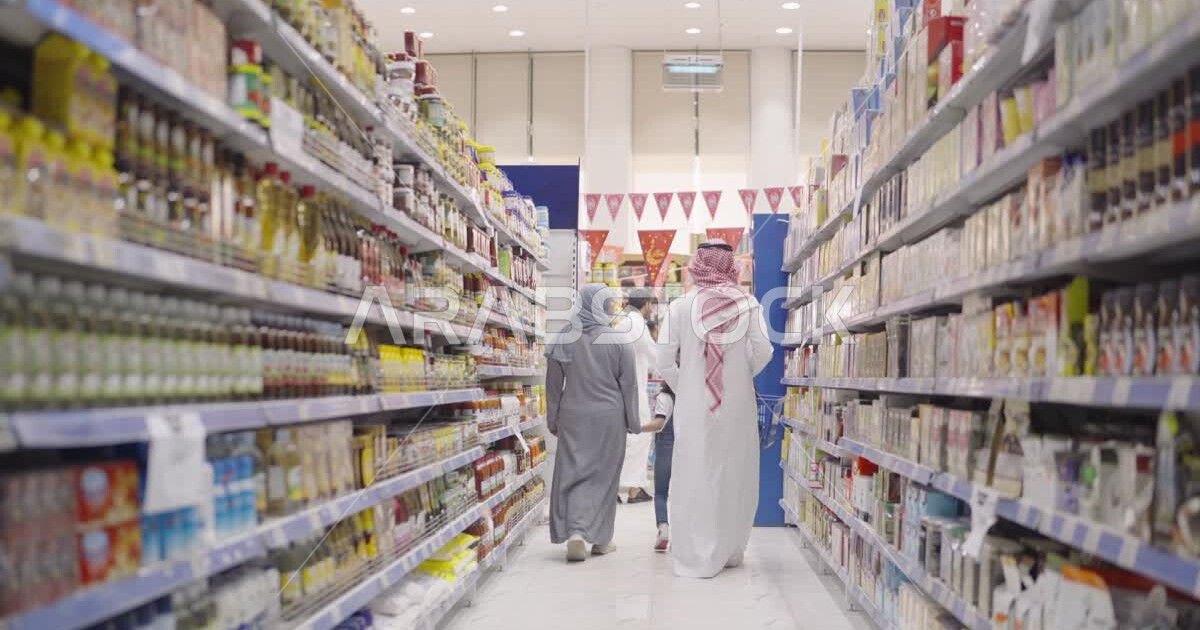 An Arab Saudi Gulf family in the supermarket, buying goods and ...