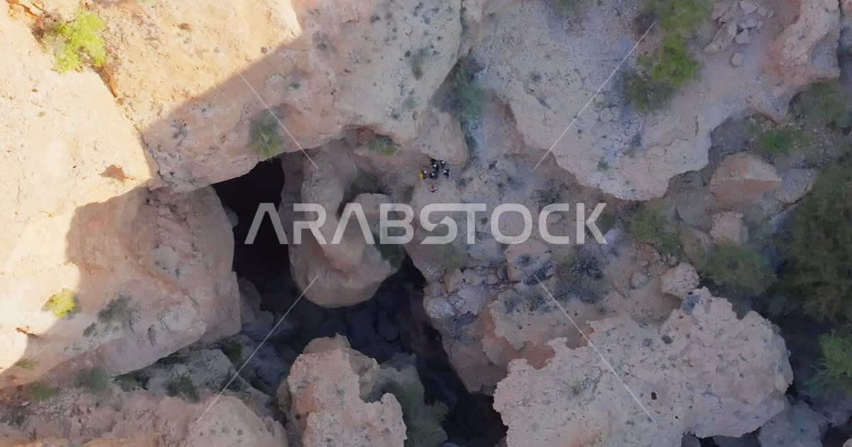 Drone photography of mountain climbers near Majlis al-Jinn Cave, the ...
