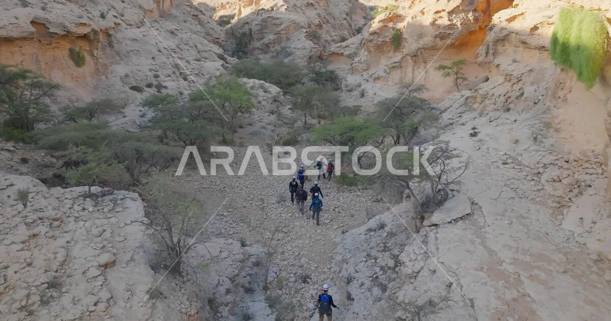 Drone photography of climbers walking towards Majlis Al Jinn Cave, the ...