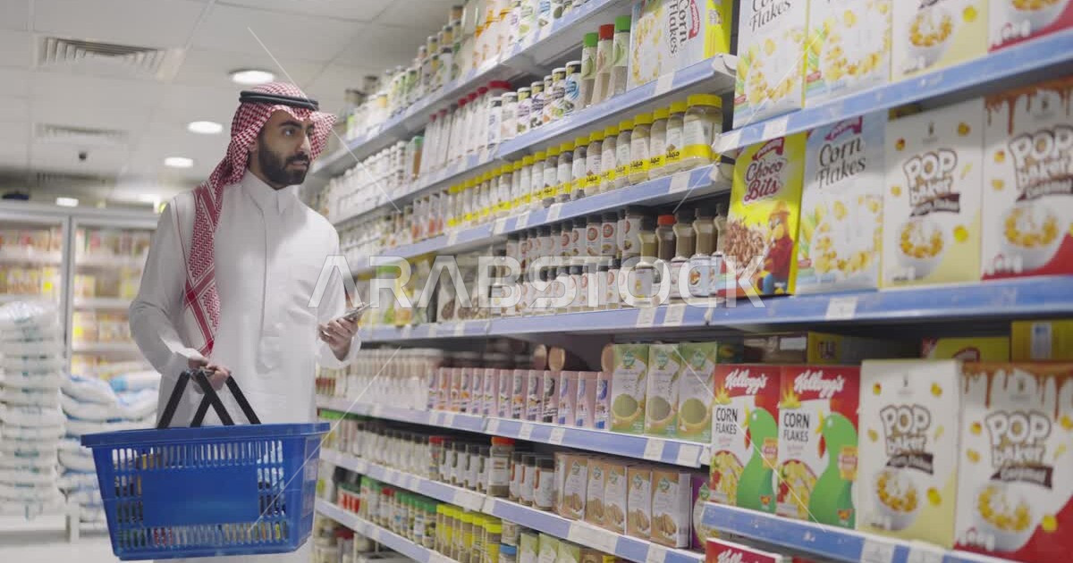 A Saudi Arabian Gulf man inside the supermarket, buying household items ...