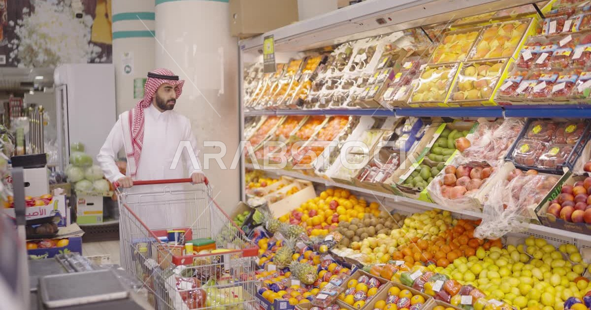 A Saudi Arabian Gulf man shopping in the fruit section of the ...