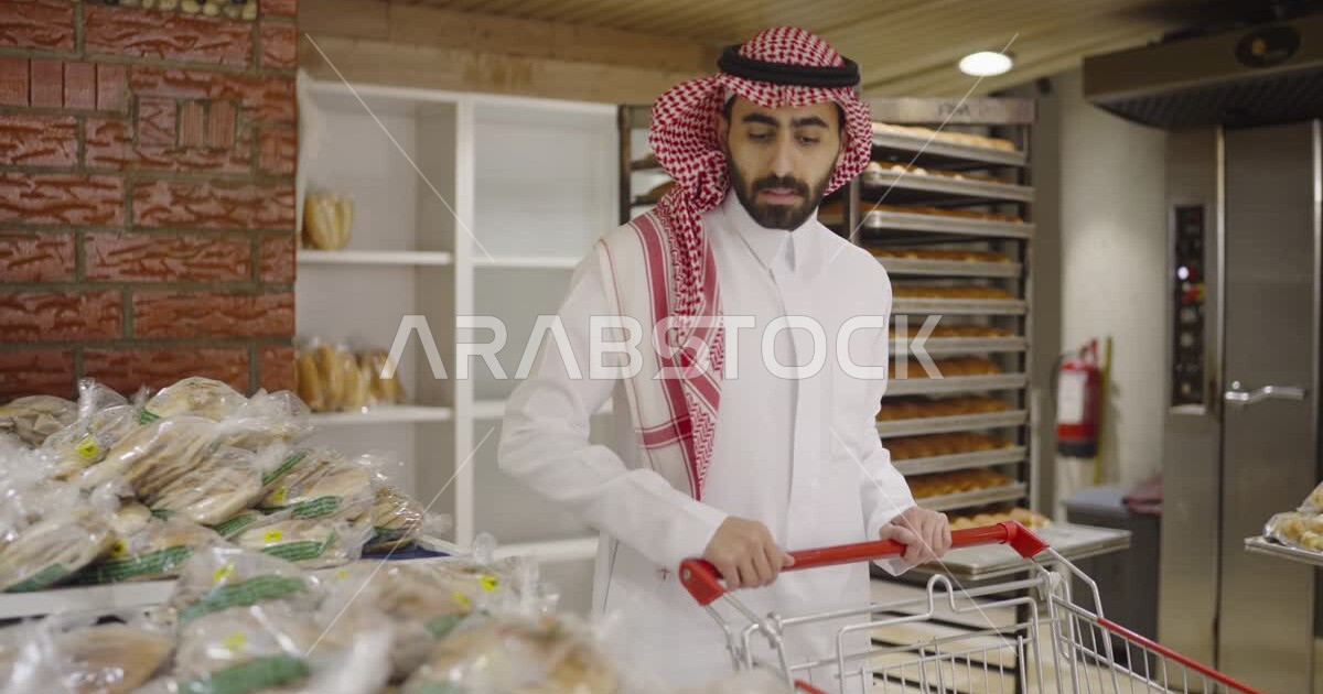 A Saudi Arabian Gulf man shopping in the bakery section inside the ...