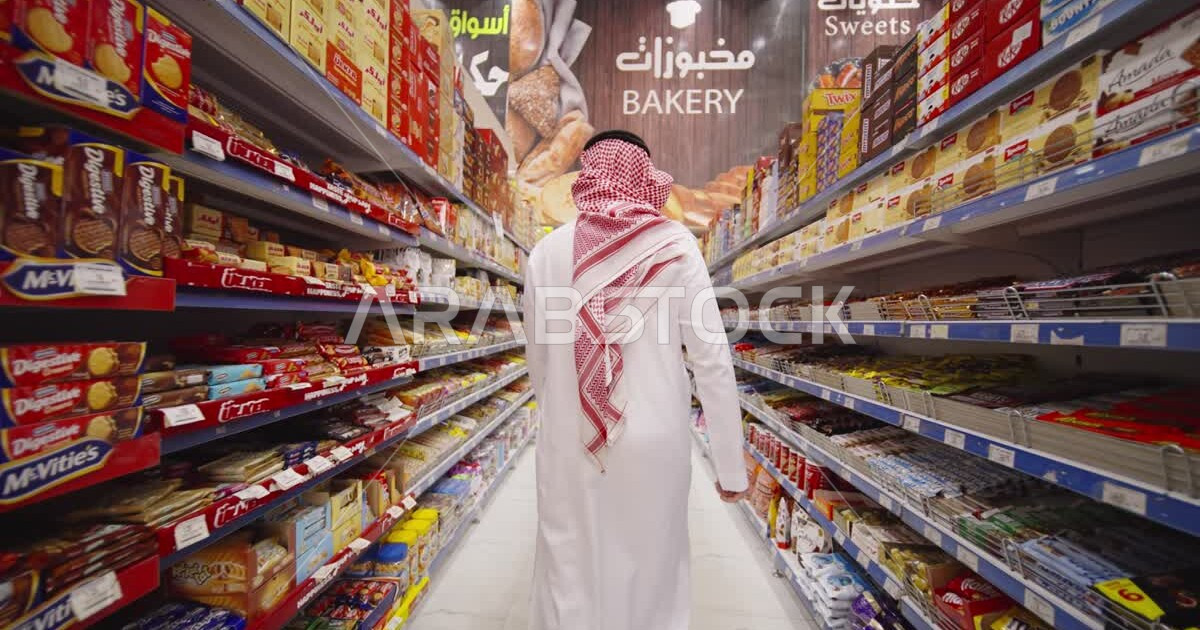 Photography from the back of a Saudi Arabian Gulf man shopping in the ...
