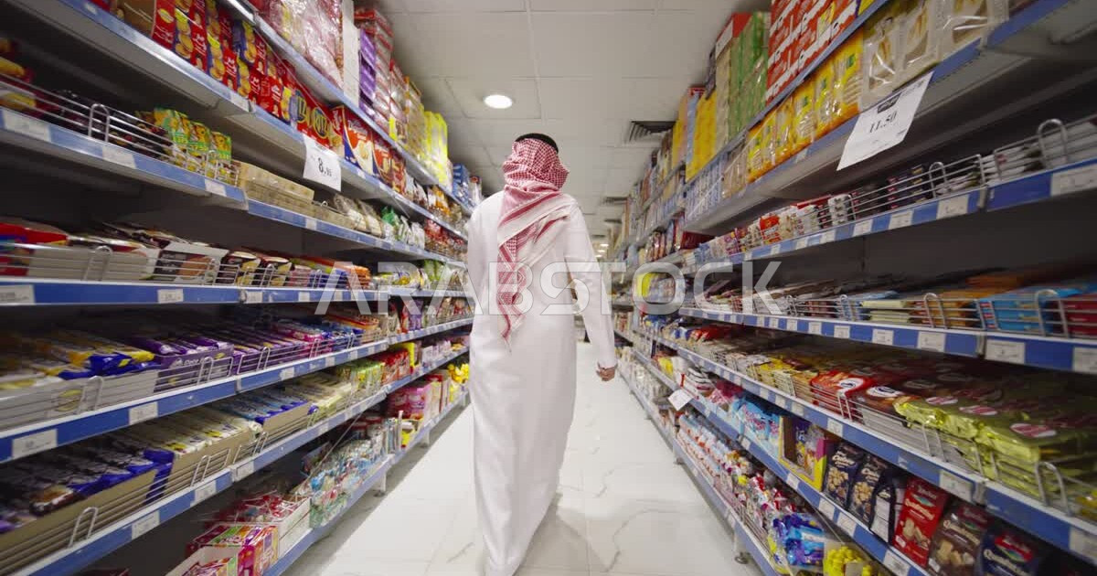 Photography from the back of a Saudi Arabian Gulf man shopping in the ...